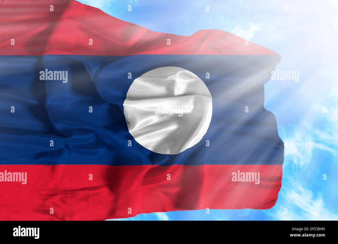 Laos waving flag against blue sky with sunrays Stock Photo - Alamy