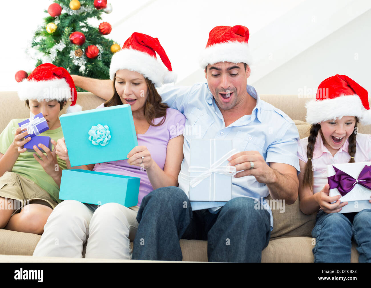 Family children opening christmas presents hi-res stock photography and ...