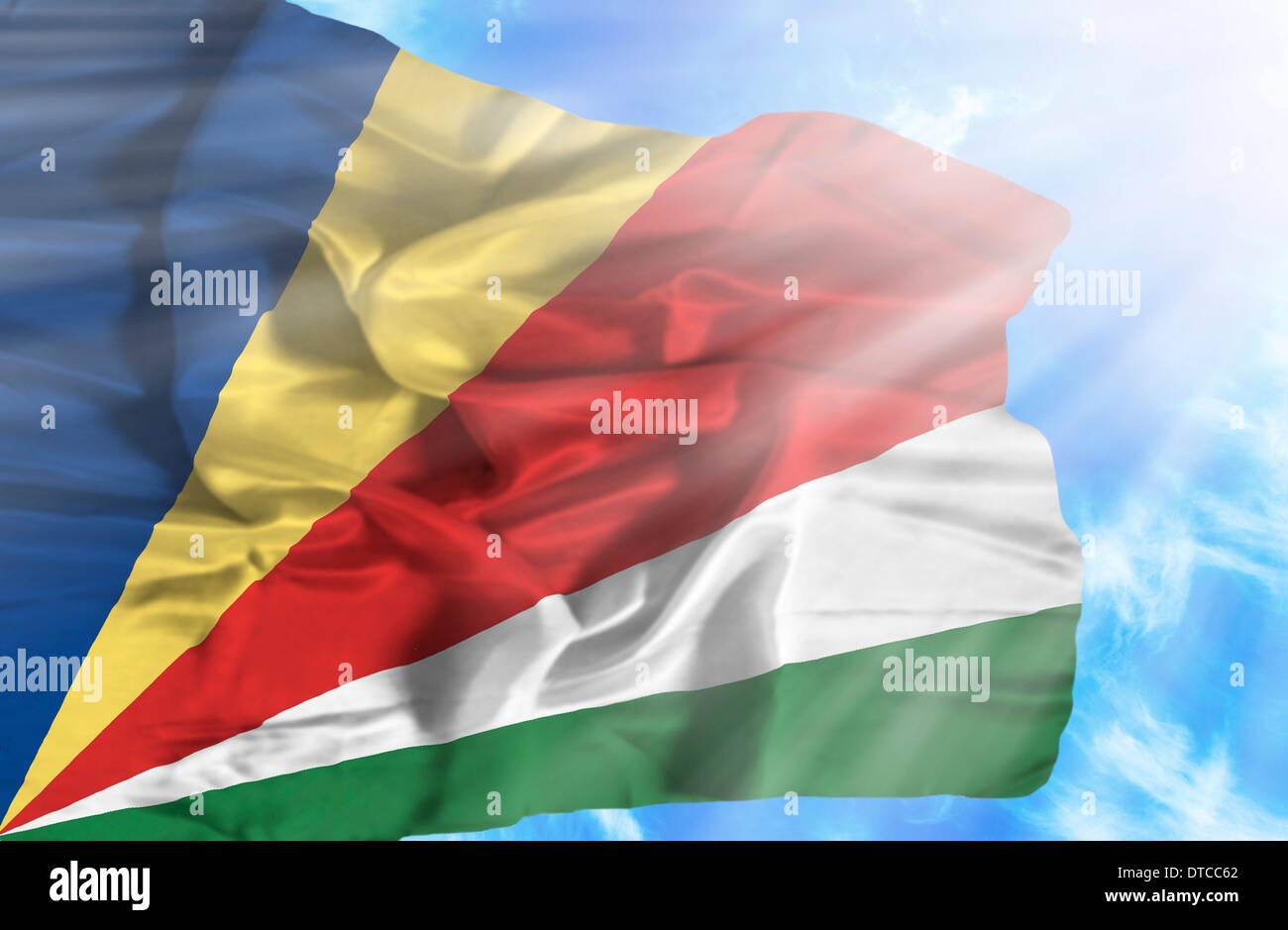Seychelles waving flag against blue sky with sunrays Stock Photo - Alamy