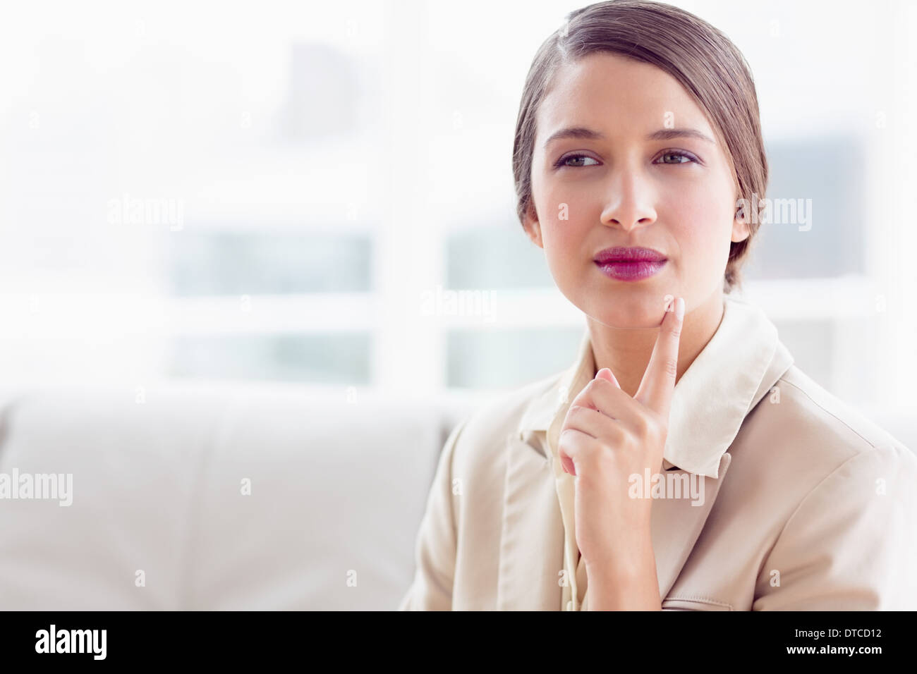 Businesswoman sitting on couch thinking hi-res stock photography and ...