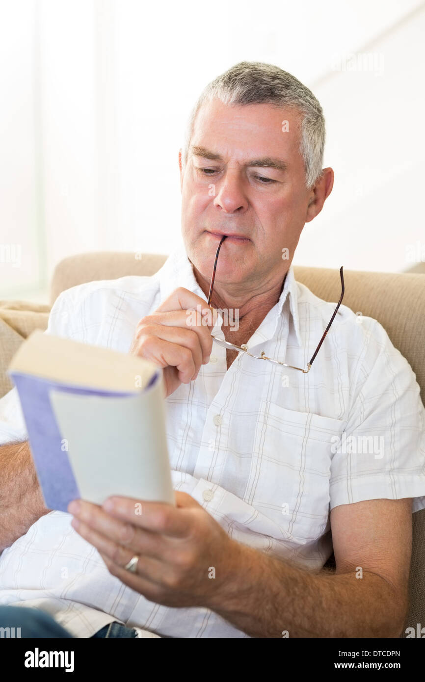 Concentrated man reading book Stock Photo - Alamy