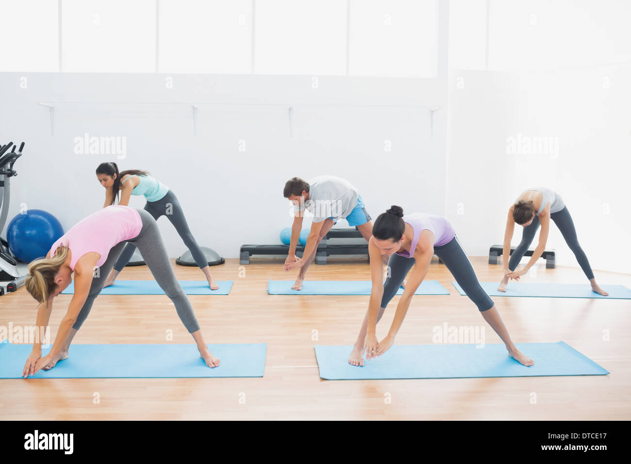 Sporty class doing pilate exercises in fitness studio Stock Photo - Alamy