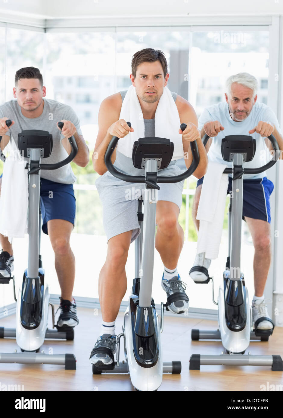 Men using exercise bikes Stock Photo - Alamy