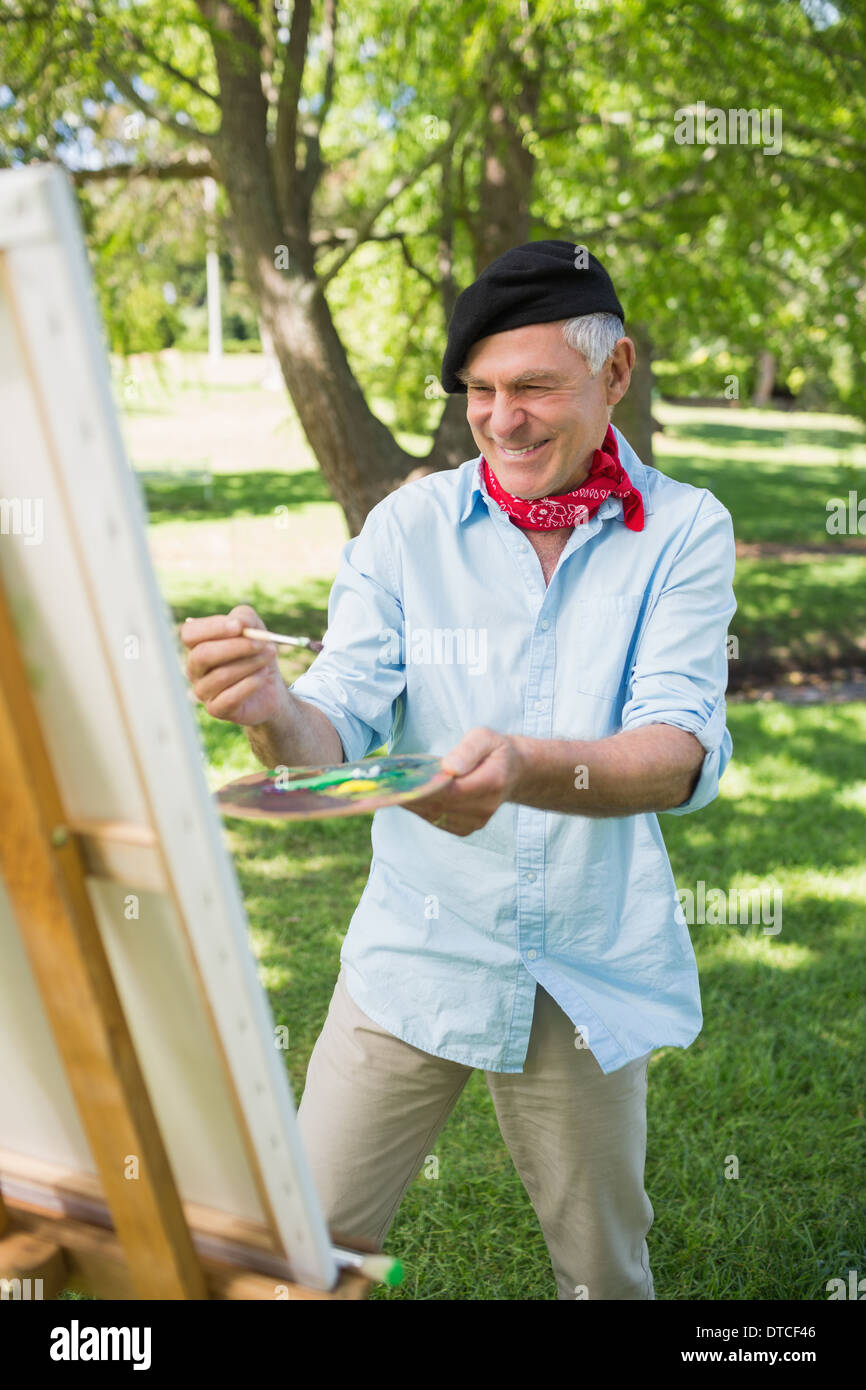 Happy mature man painting in park Stock Photo - Alamy