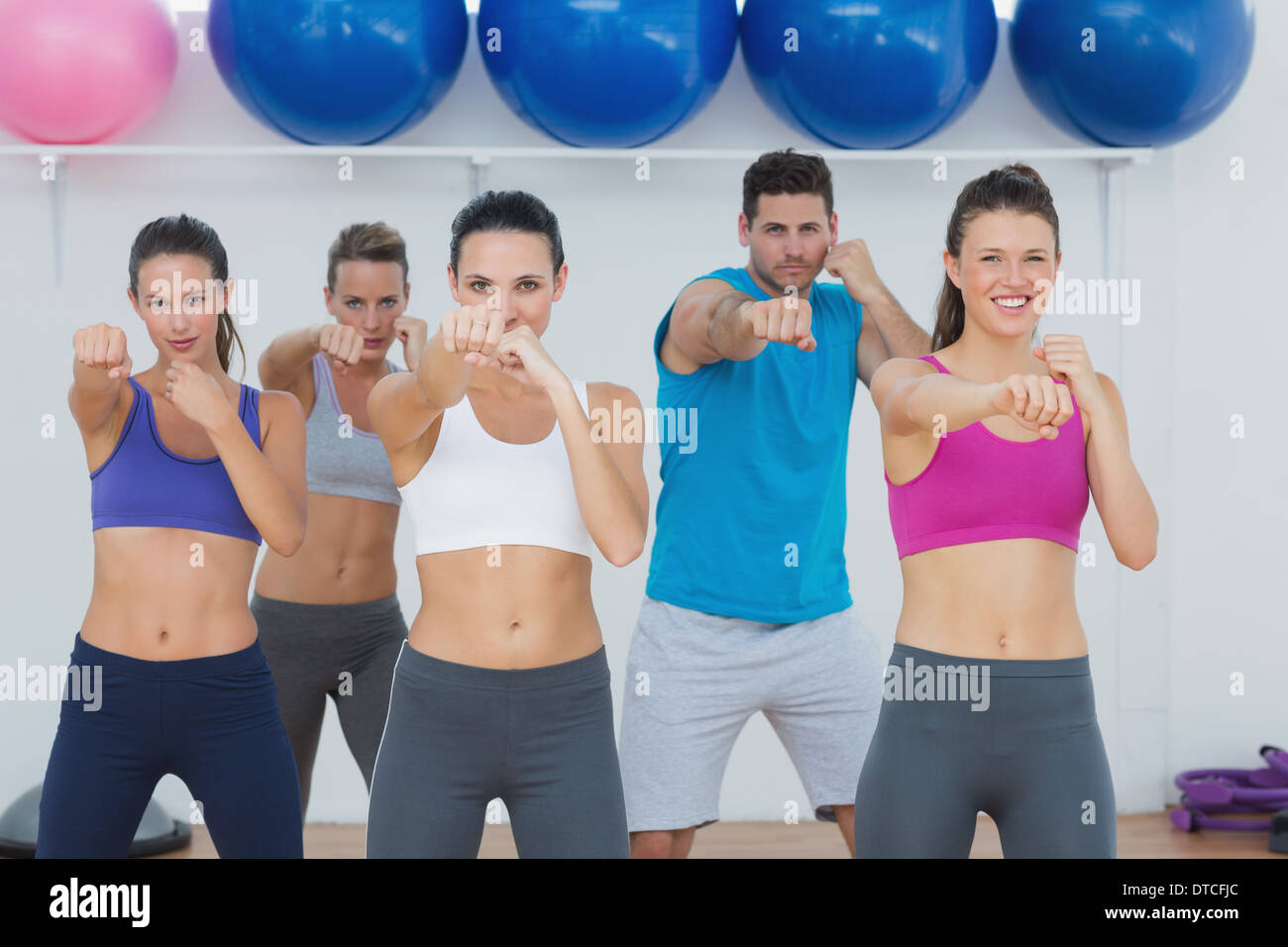 Smiling people doing power fitness exercise at yoga class Stock Photo ...