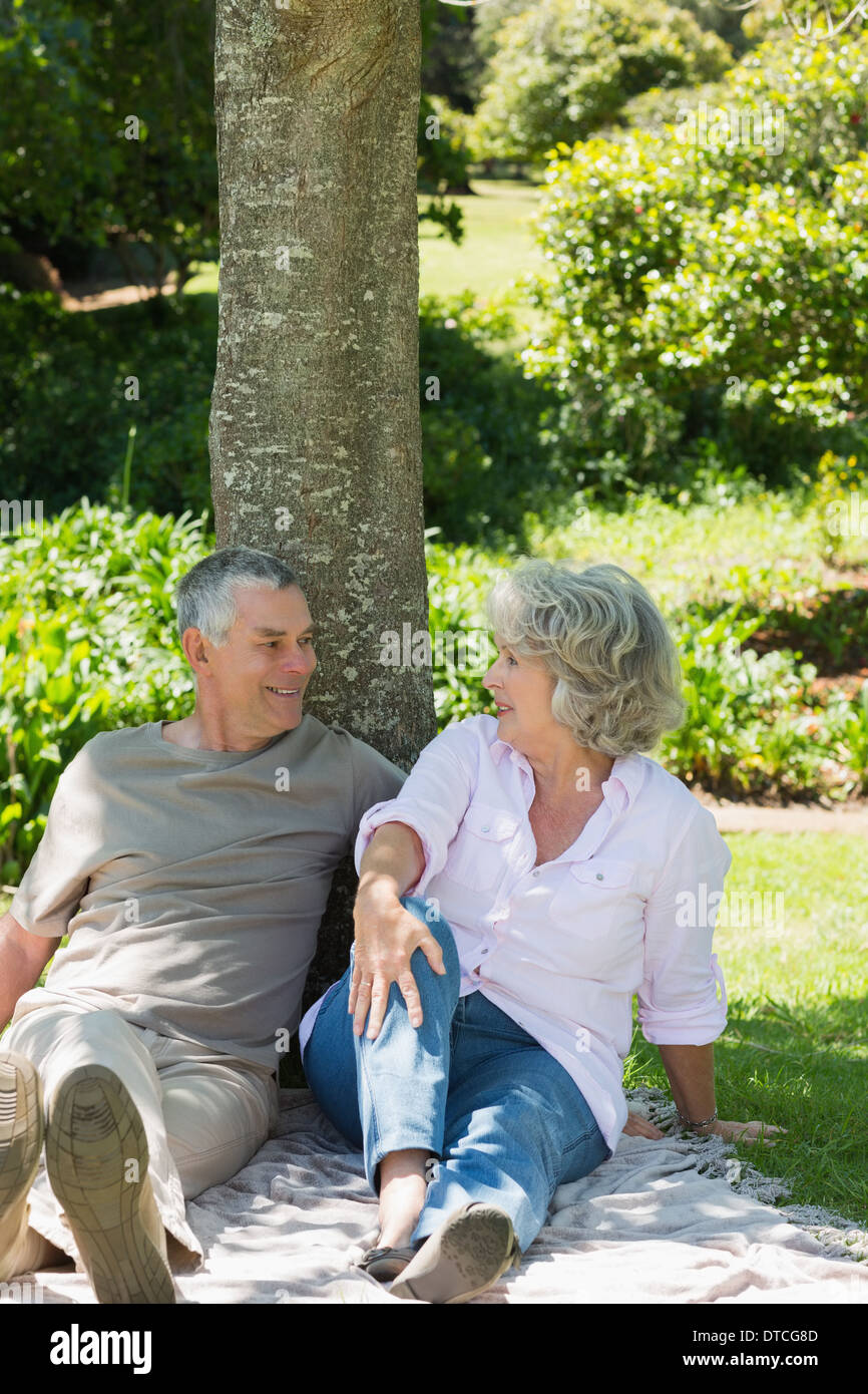 Man sitting against tree trunk hi-res stock photography and images - Alamy