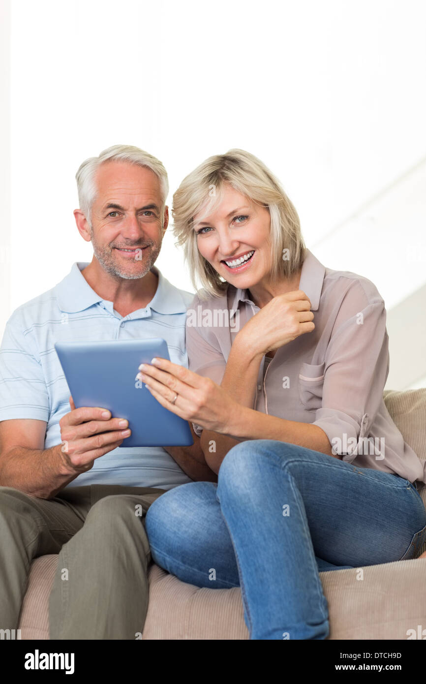 Smiling mature couple using digital tablet at home Stock Photo - Alamy