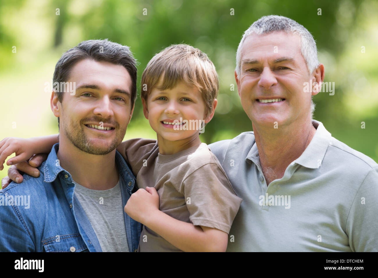 Grandfather father and son smiling at park Stock Photo - Alamy