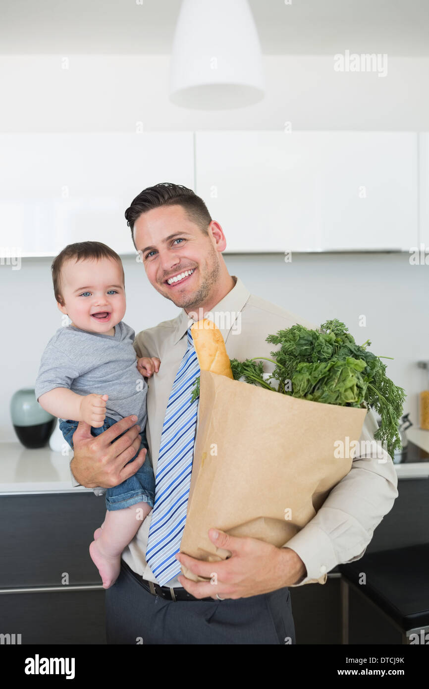 Father carrying baby boy and vegetables Stock Photo - Alamy