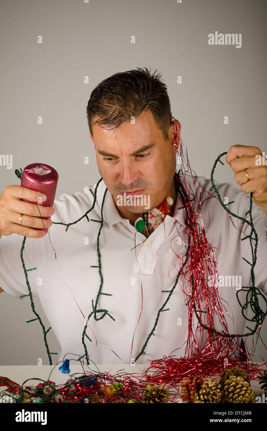 Guy tangled in between a mess of party decoration Stock Photo - Alamy