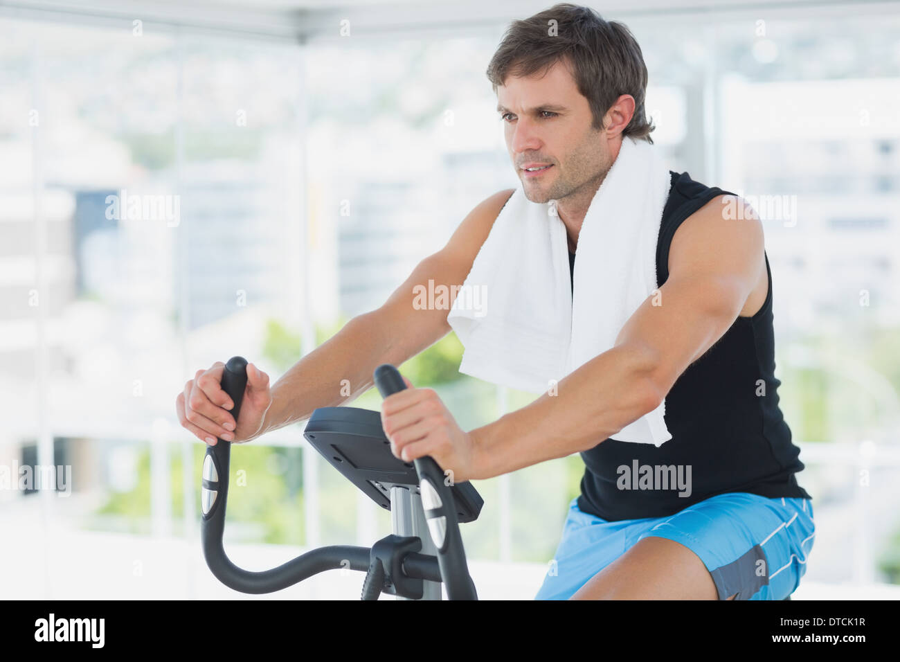 Smiling man working out at spinning class in bright gym Stock Photo - Alamy