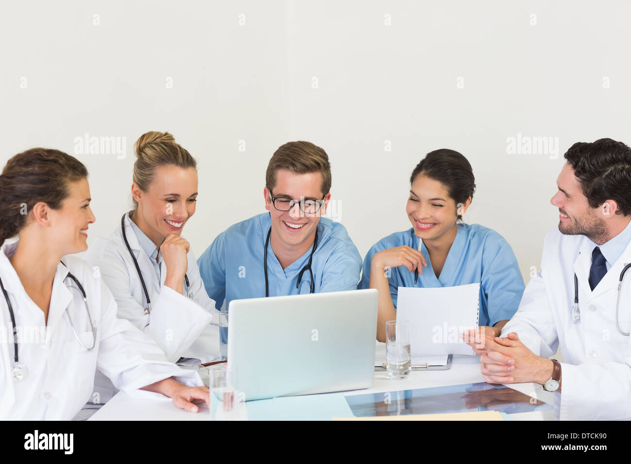 Medical team discussing over laptop Stock Photo - Alamy