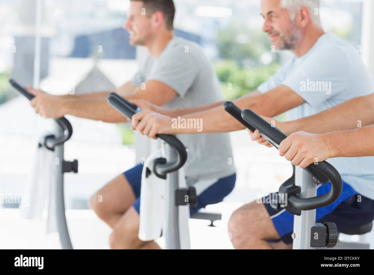 Men exercising on fitness bikes Stock Photo - Alamy