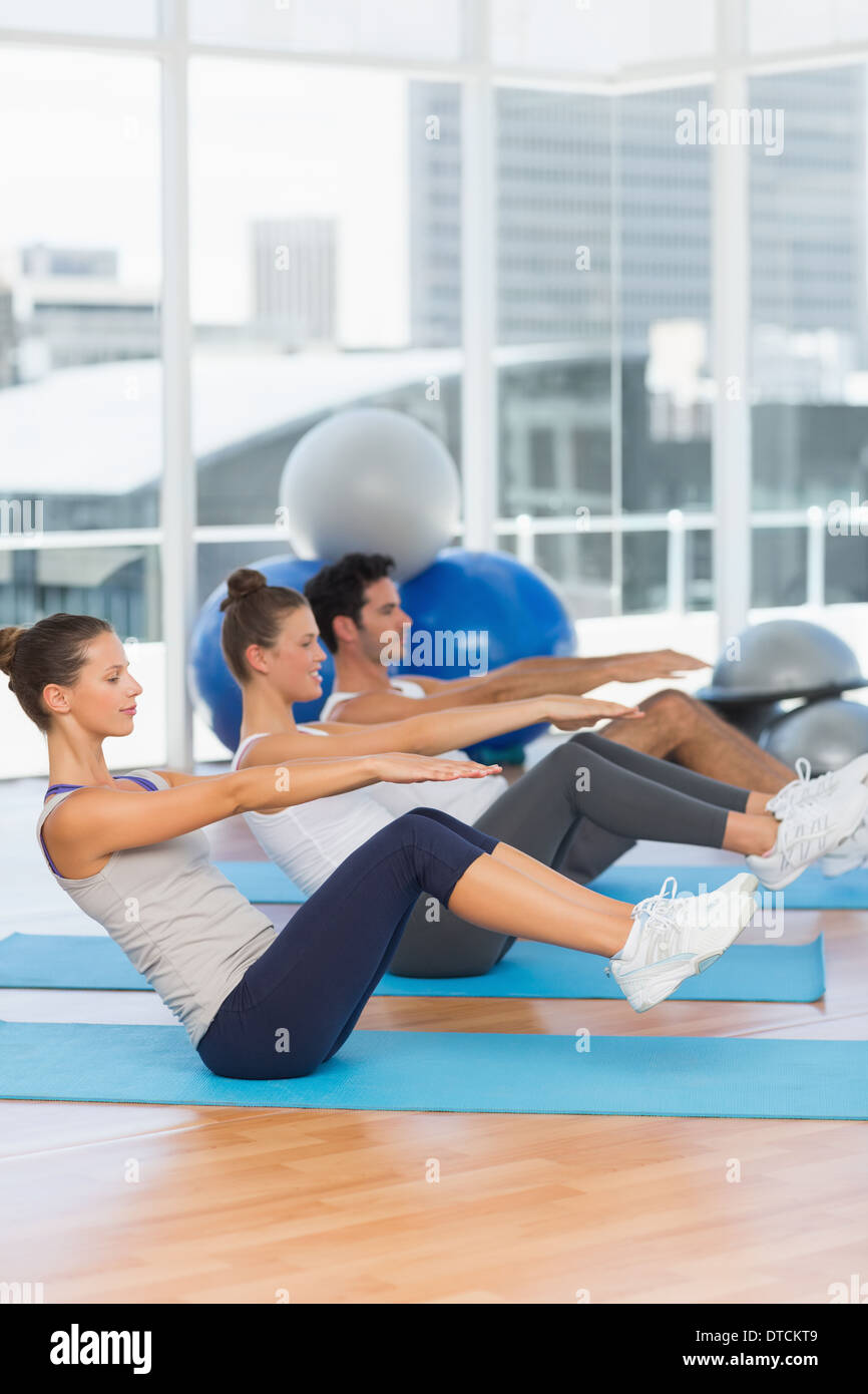 Class stretching on mats at yoga class Stock Photo - Alamy