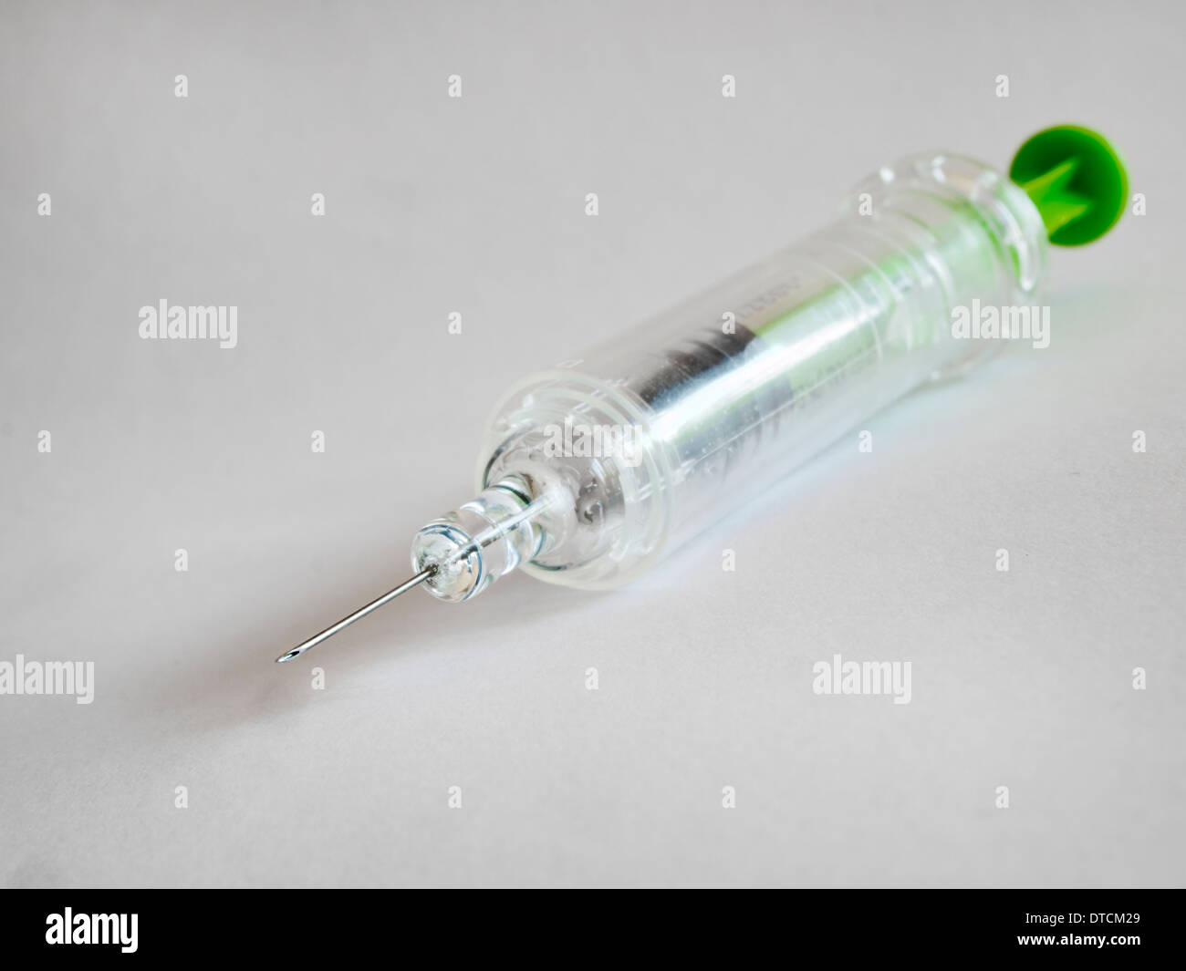 close-up of injection needle / syringe on neutral white background ...