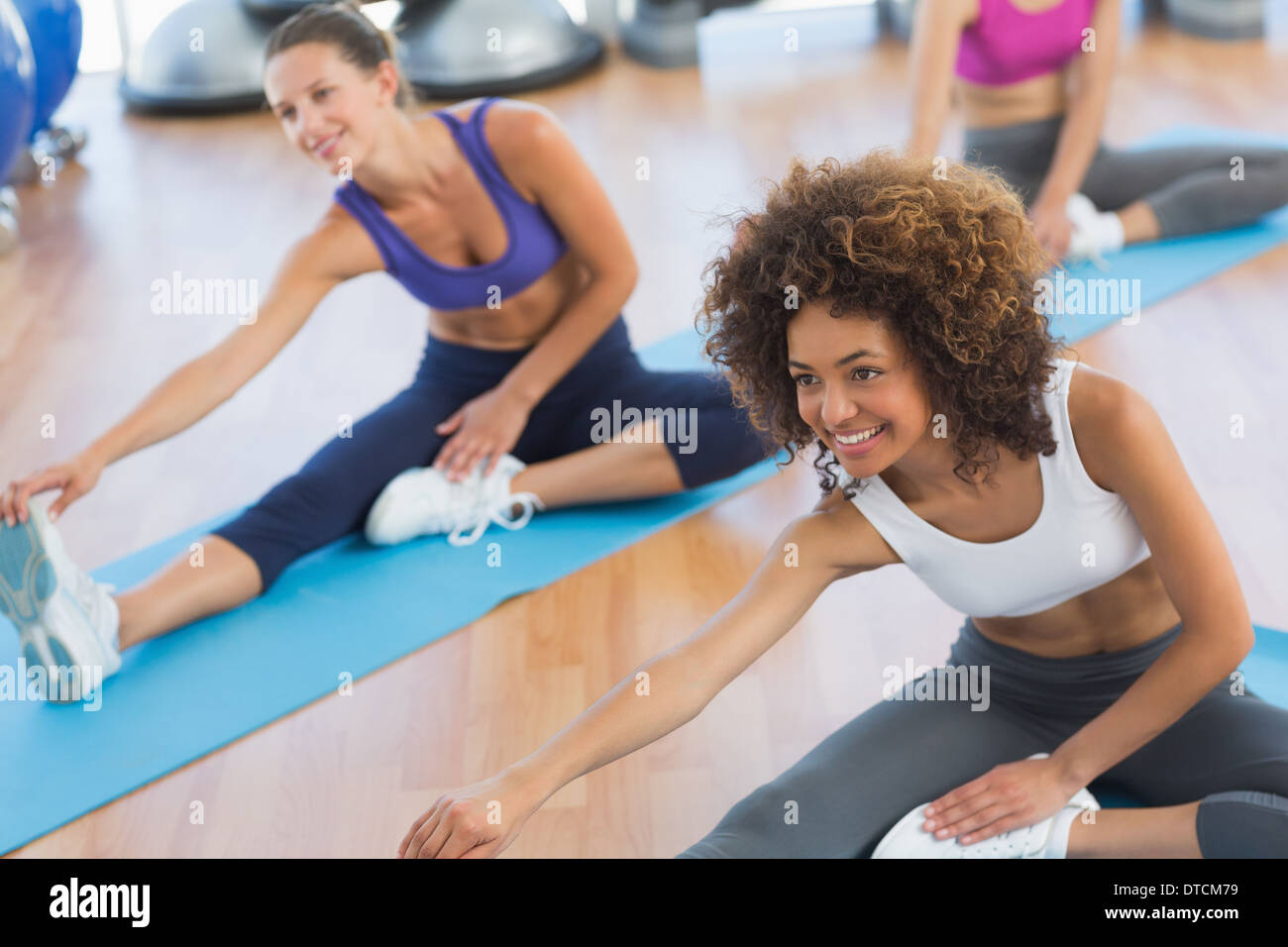 People doing stretching exercises in fitness studio Stock Photo - Alamy