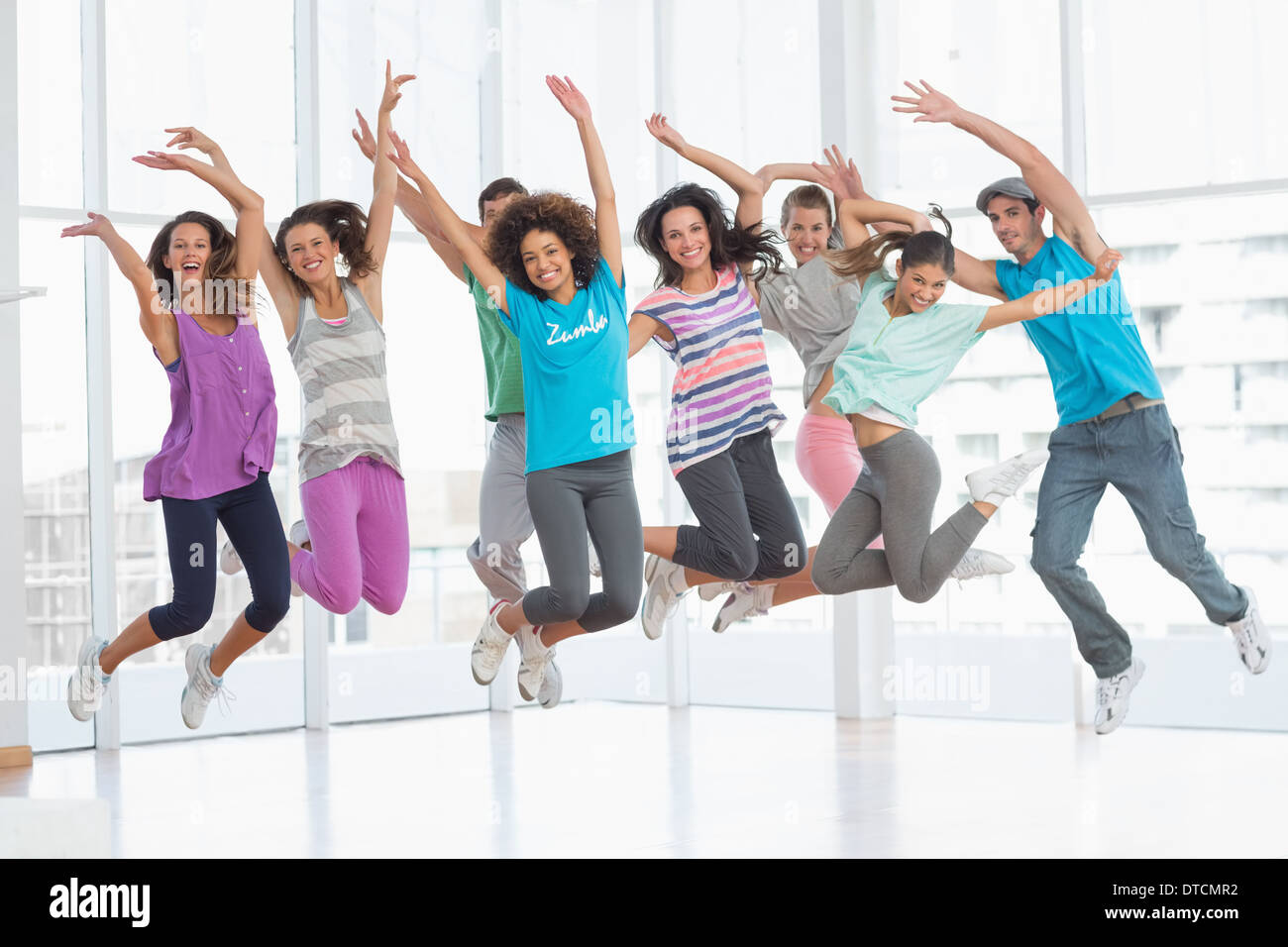 Fitness class jumping in fitness studio Stock Photo - Alamy