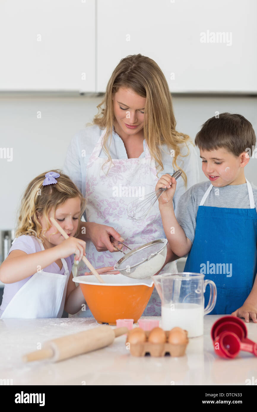 Children with mother baking cookies at counter top Stock Photo - Alamy