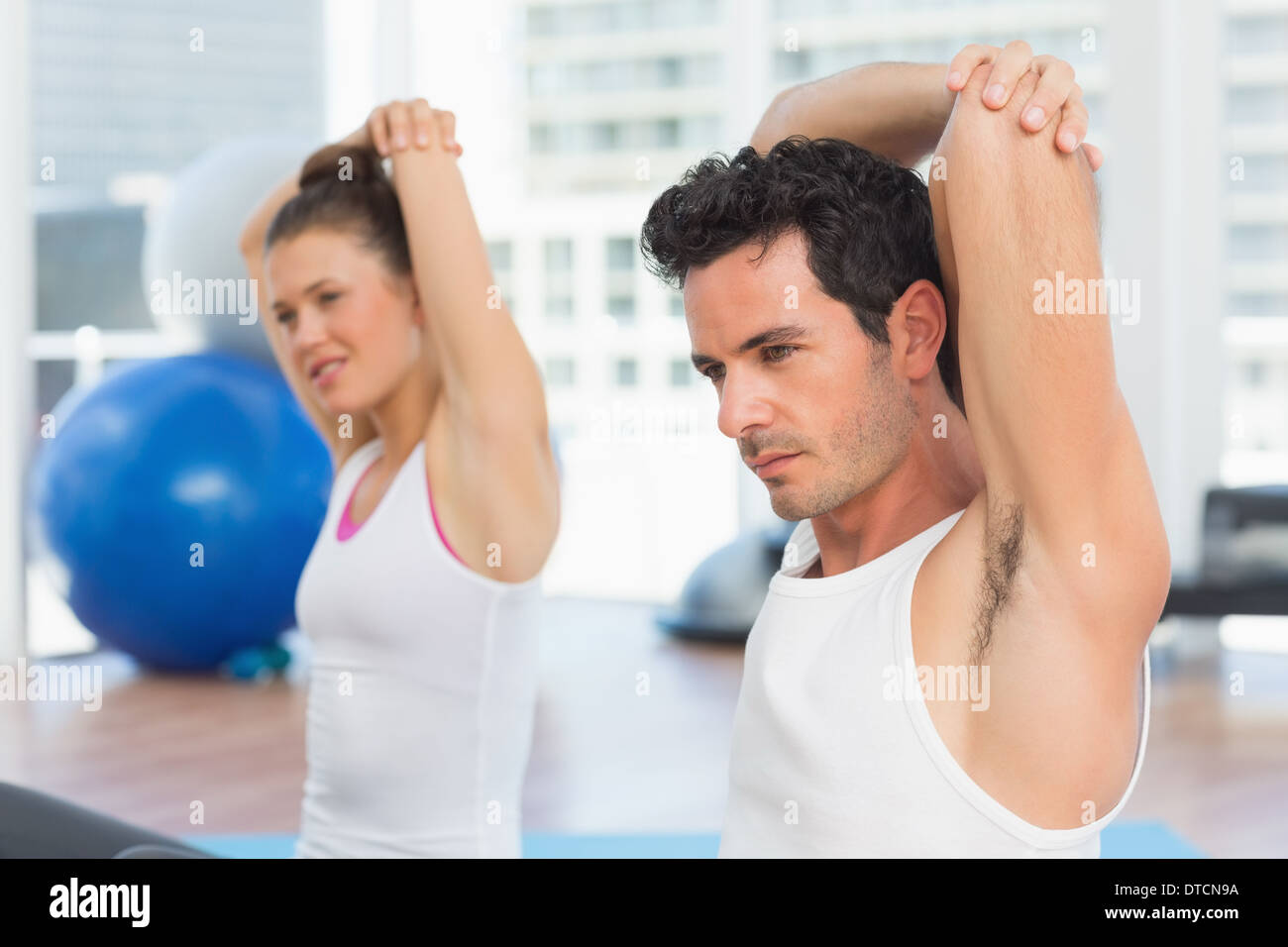 Sporty people stretching hands at yoga class Stock Photo - Alamy