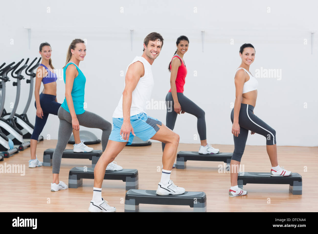 Fitness class performing step aerobics exercise Stock Photo - Alamy