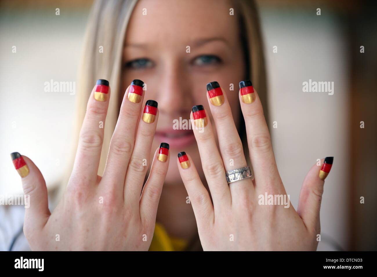 Anke Karstens of Germany shows her fingernails with German flags ...
