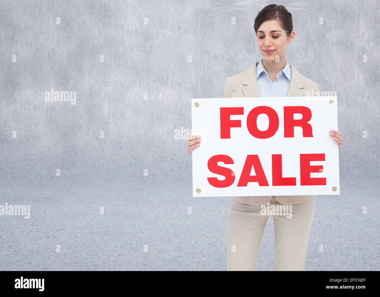 Composite image of estate agent holding for sale sign Stock Photo - Alamy
