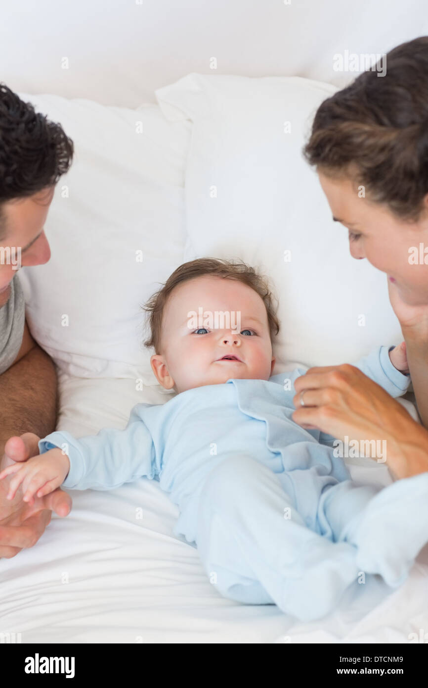 Caring parents playing with baby Stock Photo - Alamy