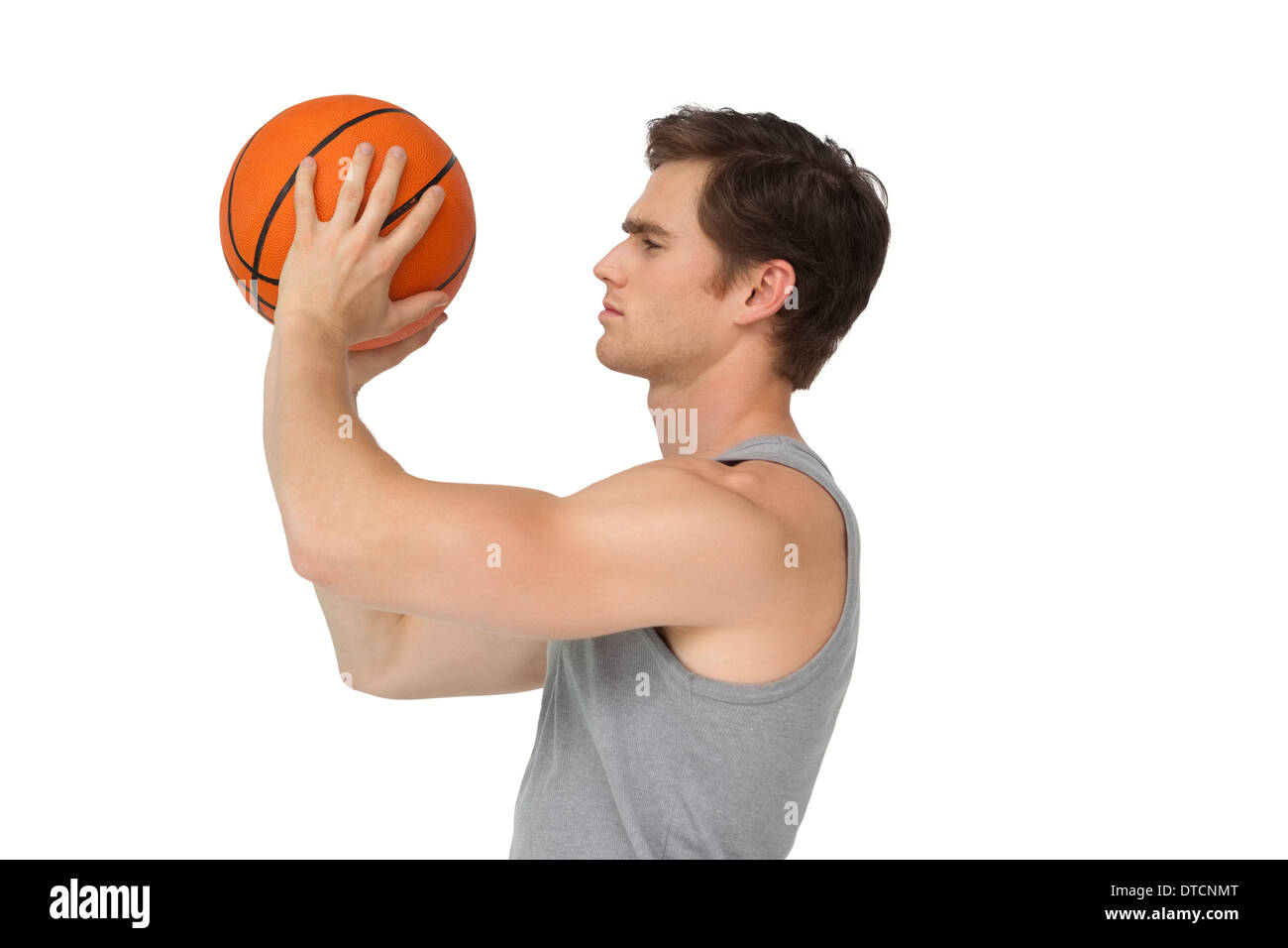 Athletic man holding basketball about to shoot Stock Photo - Alamy
