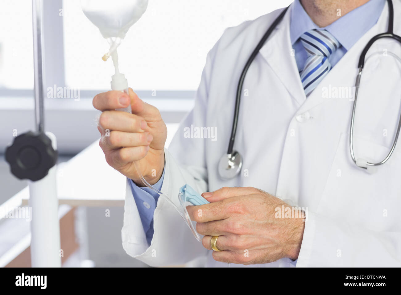 Doctor examining IV drip Stock Photo - Alamy