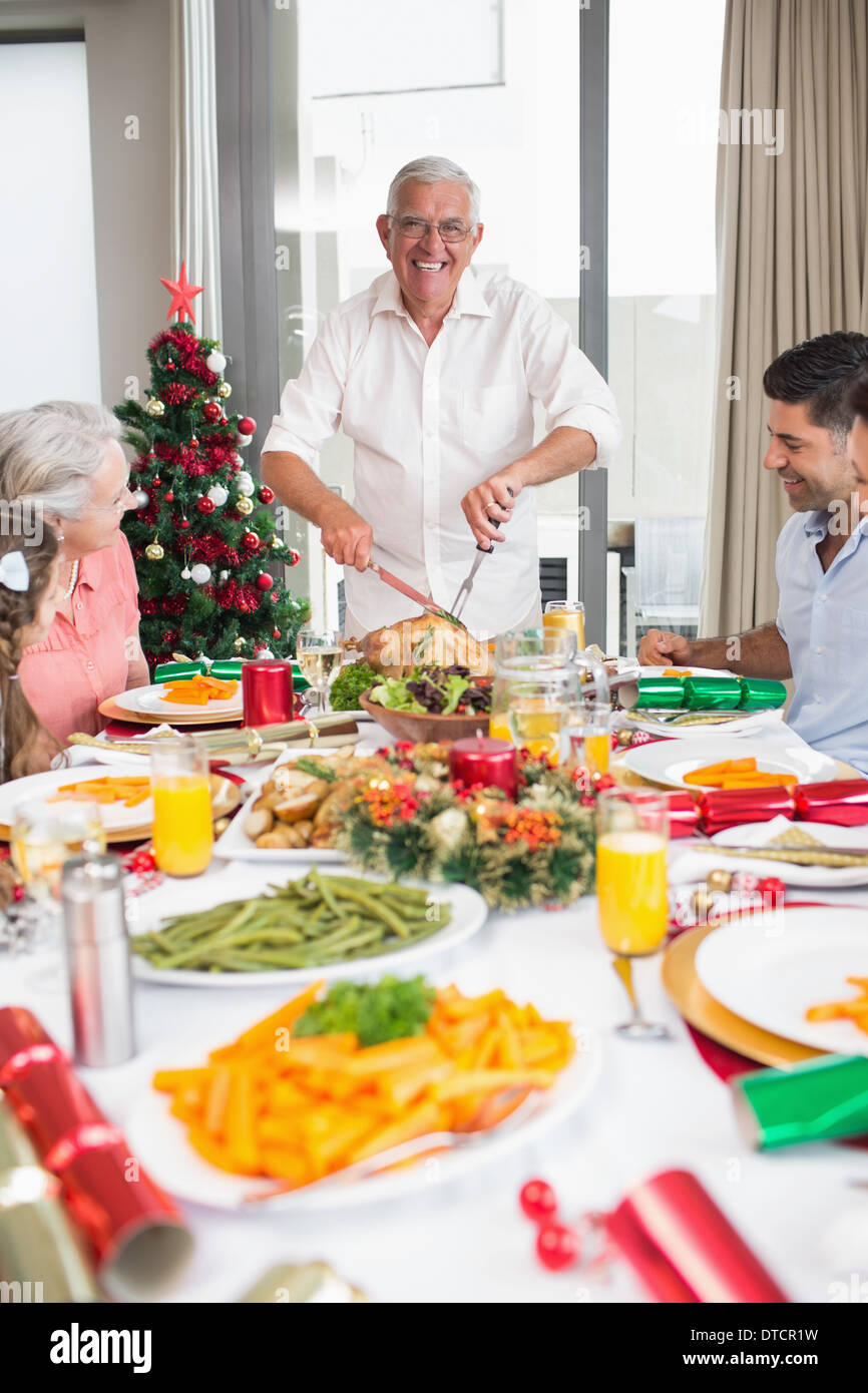 Cheerful family at dining table for christmas dinner Stock Photo - Alamy