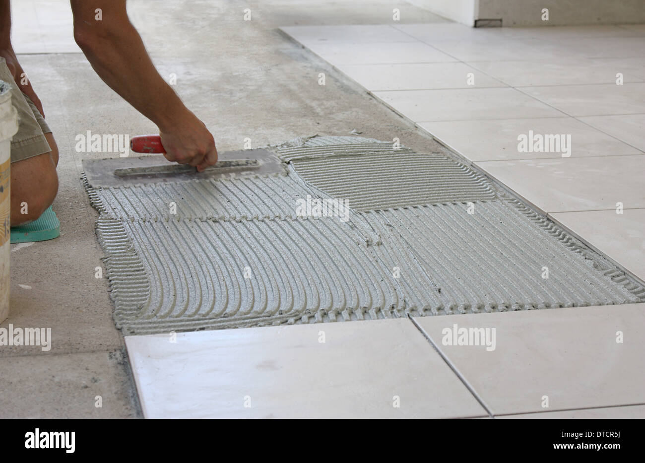 Man tiling floor hi-res stock photography and images - Alamy