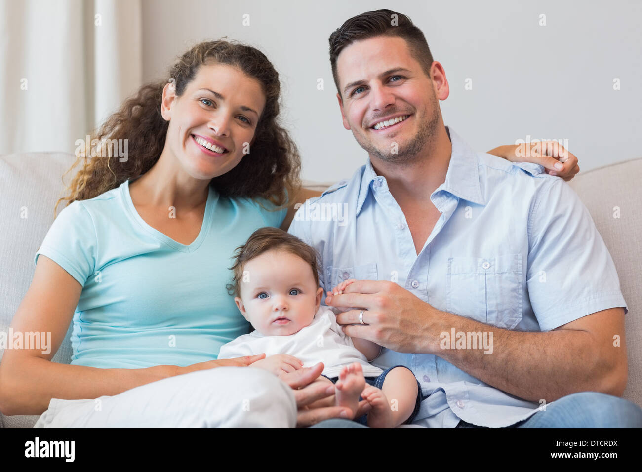 Parents smiling holding little baby hi-res stock photography and images ...