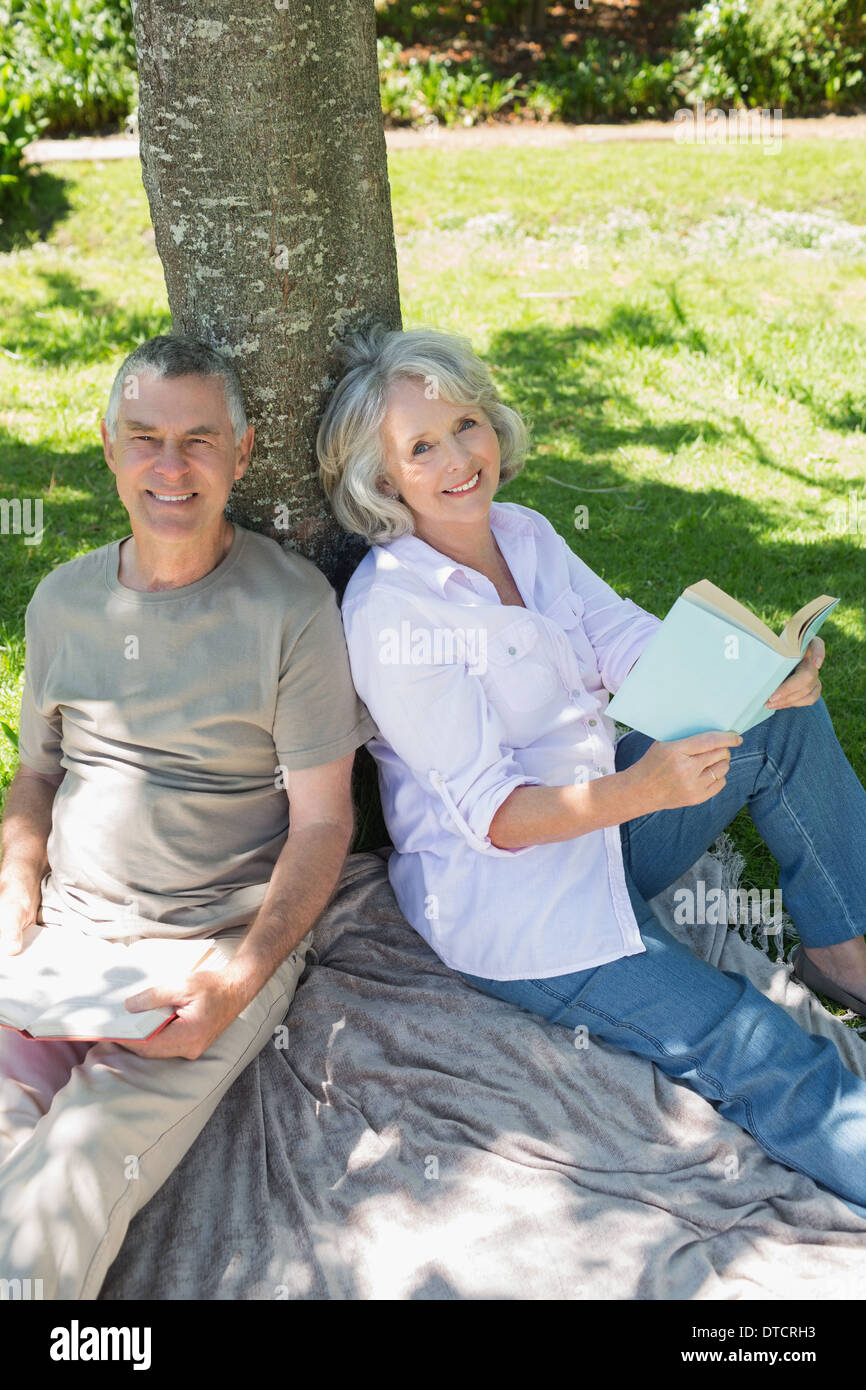Man sitting against tree trunk hi-res stock photography and images - Alamy