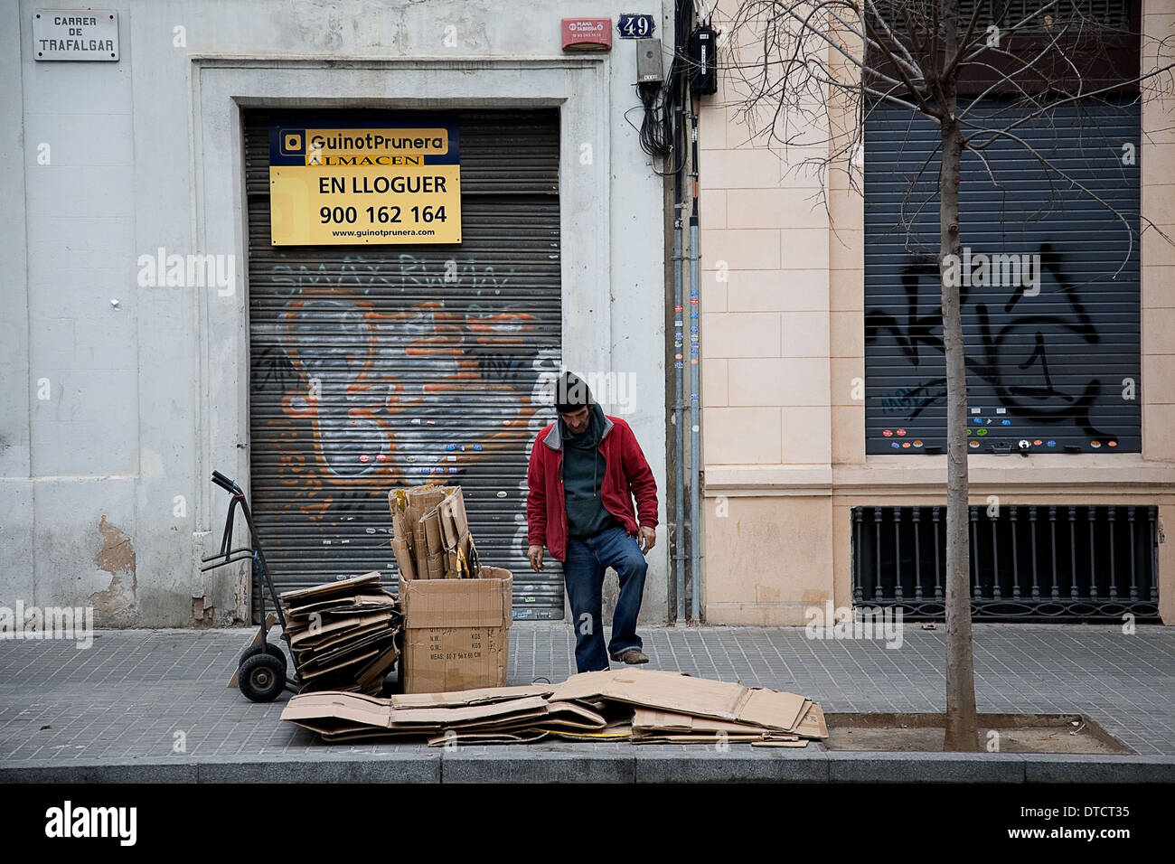 Homeless man collecting cardboard in the city of Barcelona Stock Photo ...