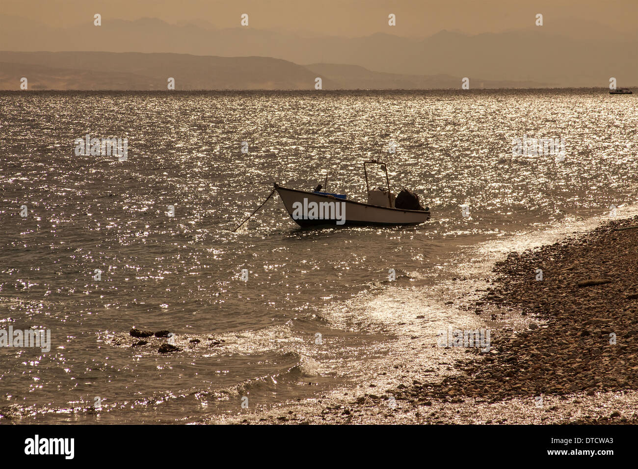 Idyllic scene with a small boat on the sea Stock Photo - Alamy