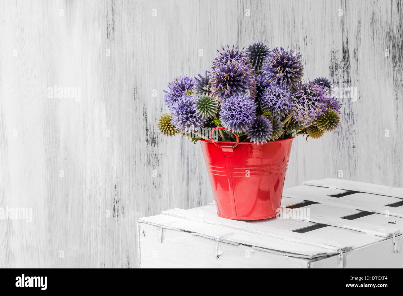 Still life with sunflower on matalic rusty cup on white wooden ...