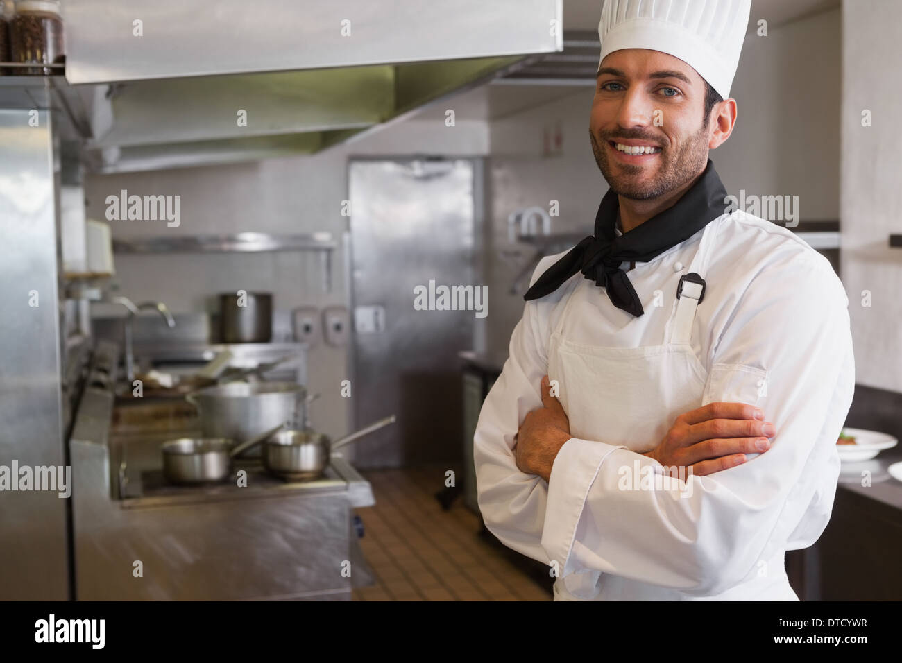 Happy head chef smiling at camera with arms crossed Stock Photo - Alamy