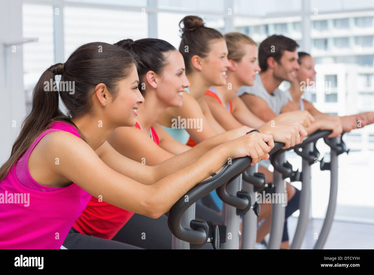 Fit people working out at spinning class Stock Photo - Alamy