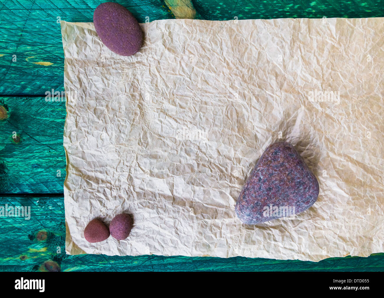 Old crumpled paper with stones on wood Stock Photo - Alamy