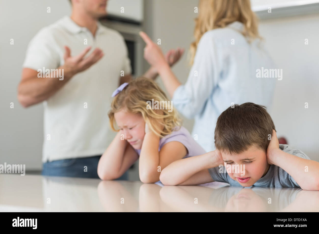 Children covering ears while parents arguing Stock Photo - Alamy