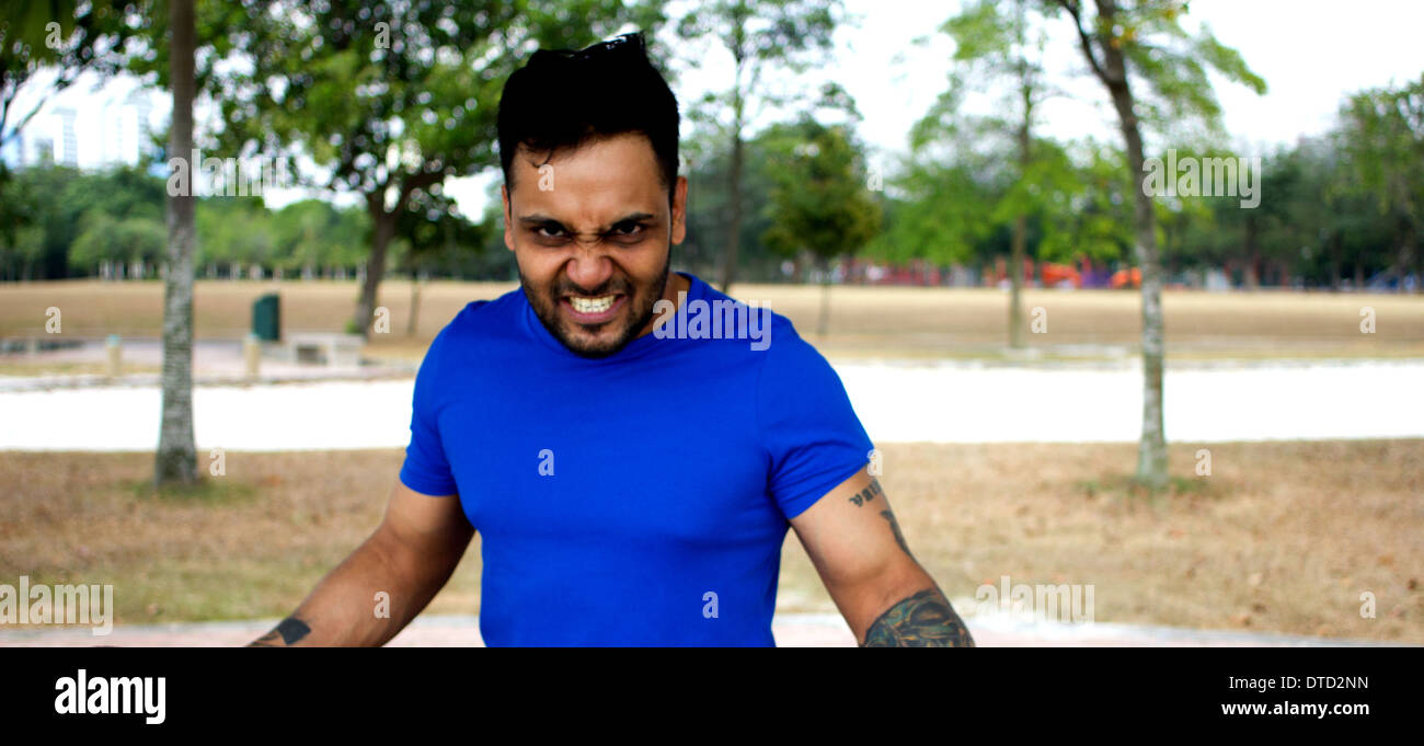 Ethnic Indian male staring in anger and baring teeth Stock Photo - Alamy