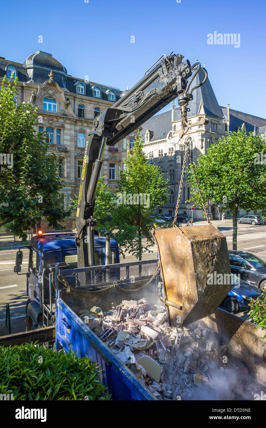 Crane loading construction rubble into truck Strasbourg Alsace France ...