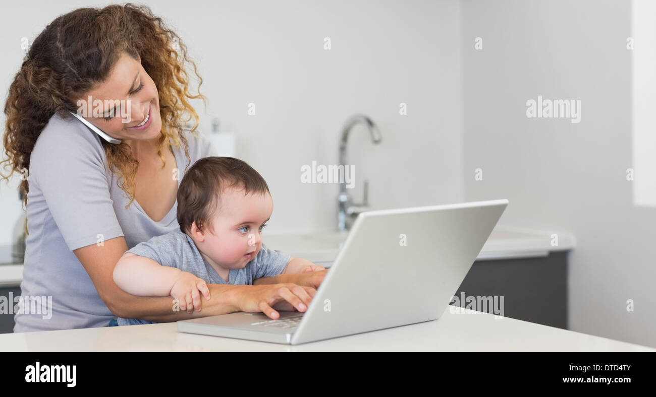 Young woman multi tasking at home Stock Photo - Alamy