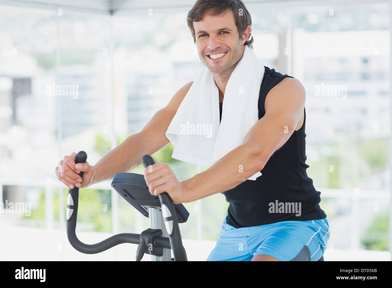 Smiling man working out at spinning class in bright gym Stock Photo - Alamy
