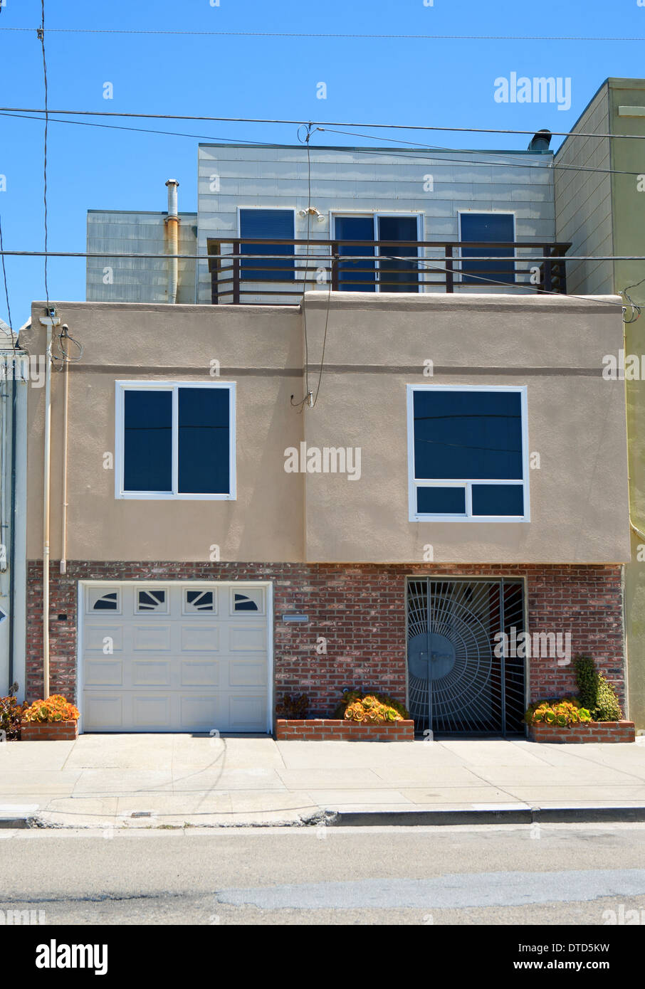 Brick and stucco row house with garage Stock Photo - Alamy
