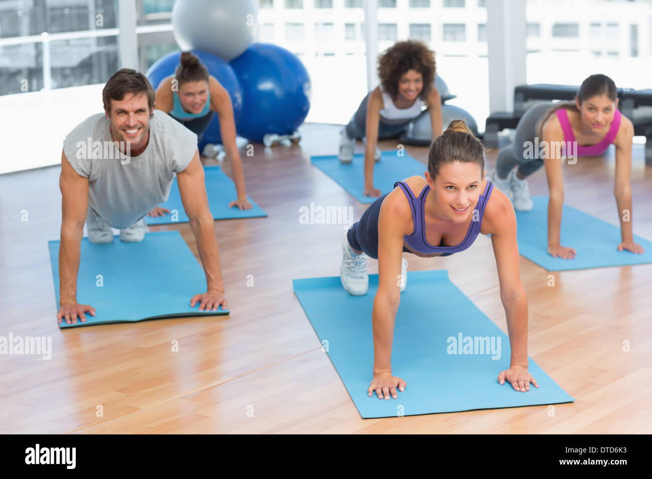 People doing push ups in fitness studio Stock Photo - Alamy