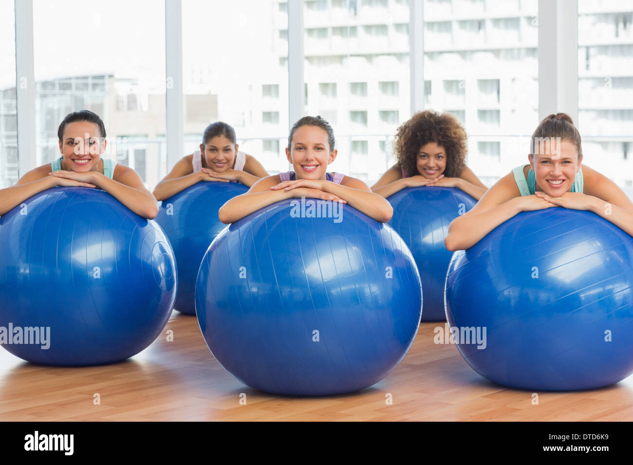 Portrait of smiling people with exercise balls Stock Photo - Alamy