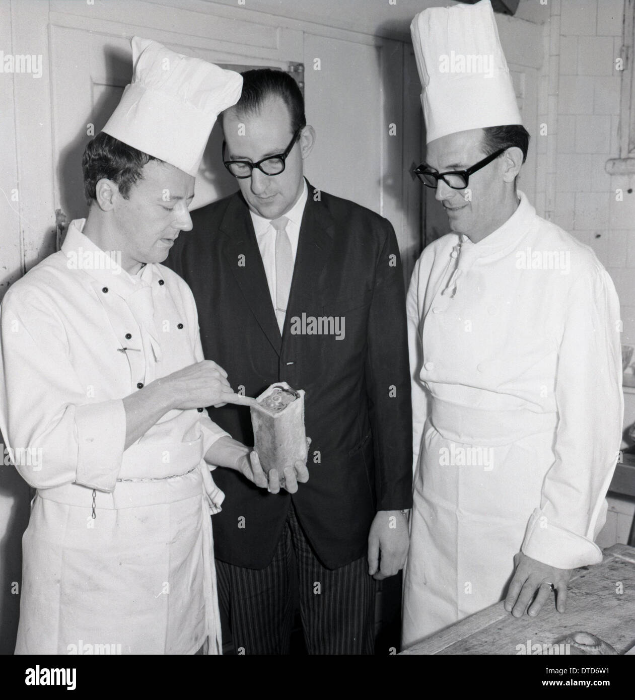 1960s. Historical image showing two professional chefs in a kitchen in ...