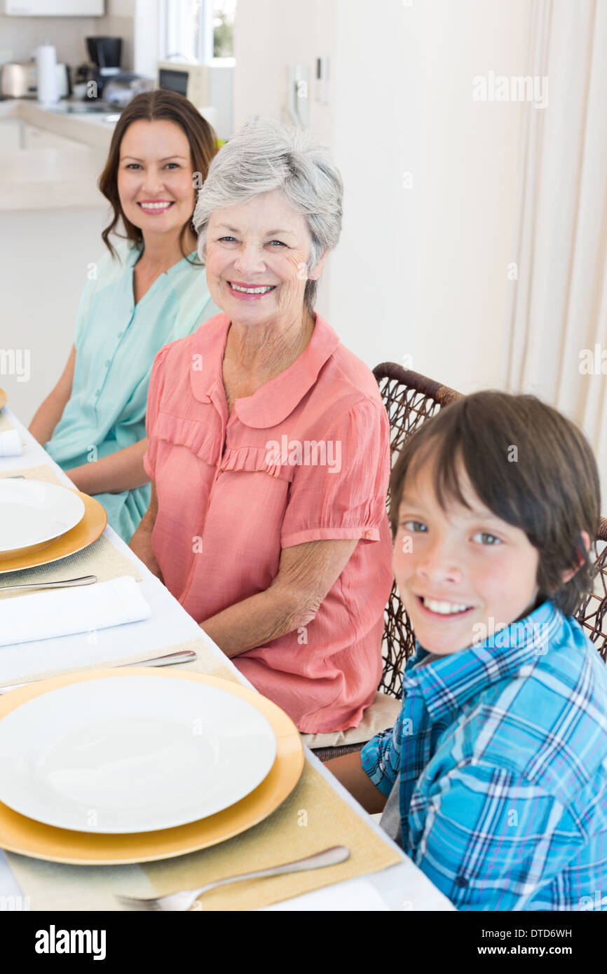 Multigeneration family sitting at dining table Stock Photo - Alamy