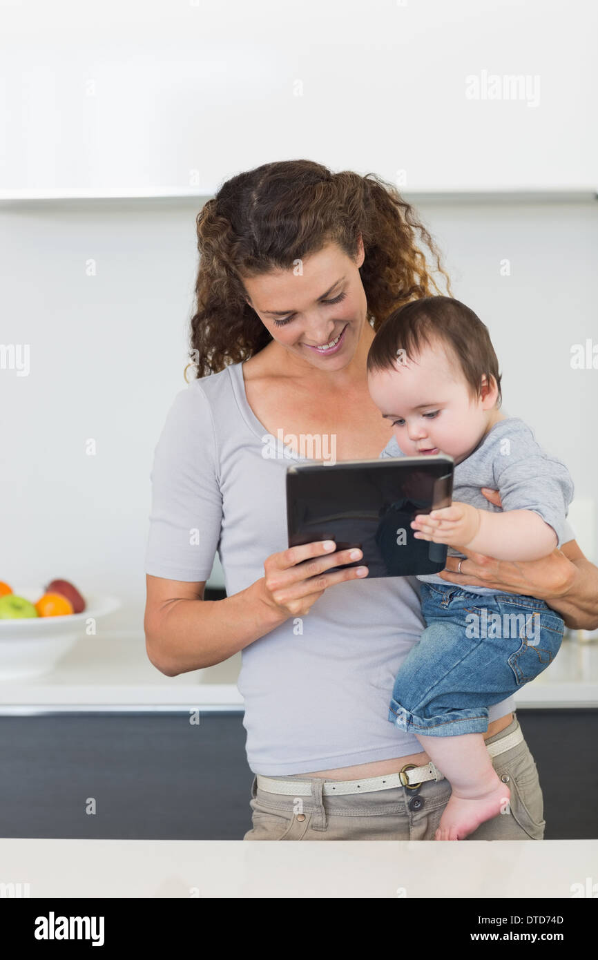 Mother and baby using digital tablet Stock Photo - Alamy